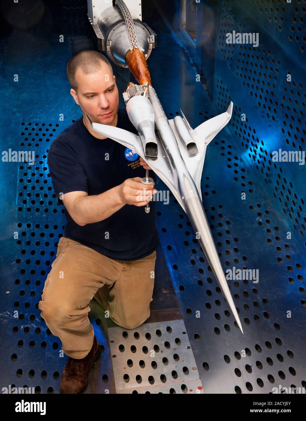 Supersonic plane concept testing. Technician preparing a scale model of ...