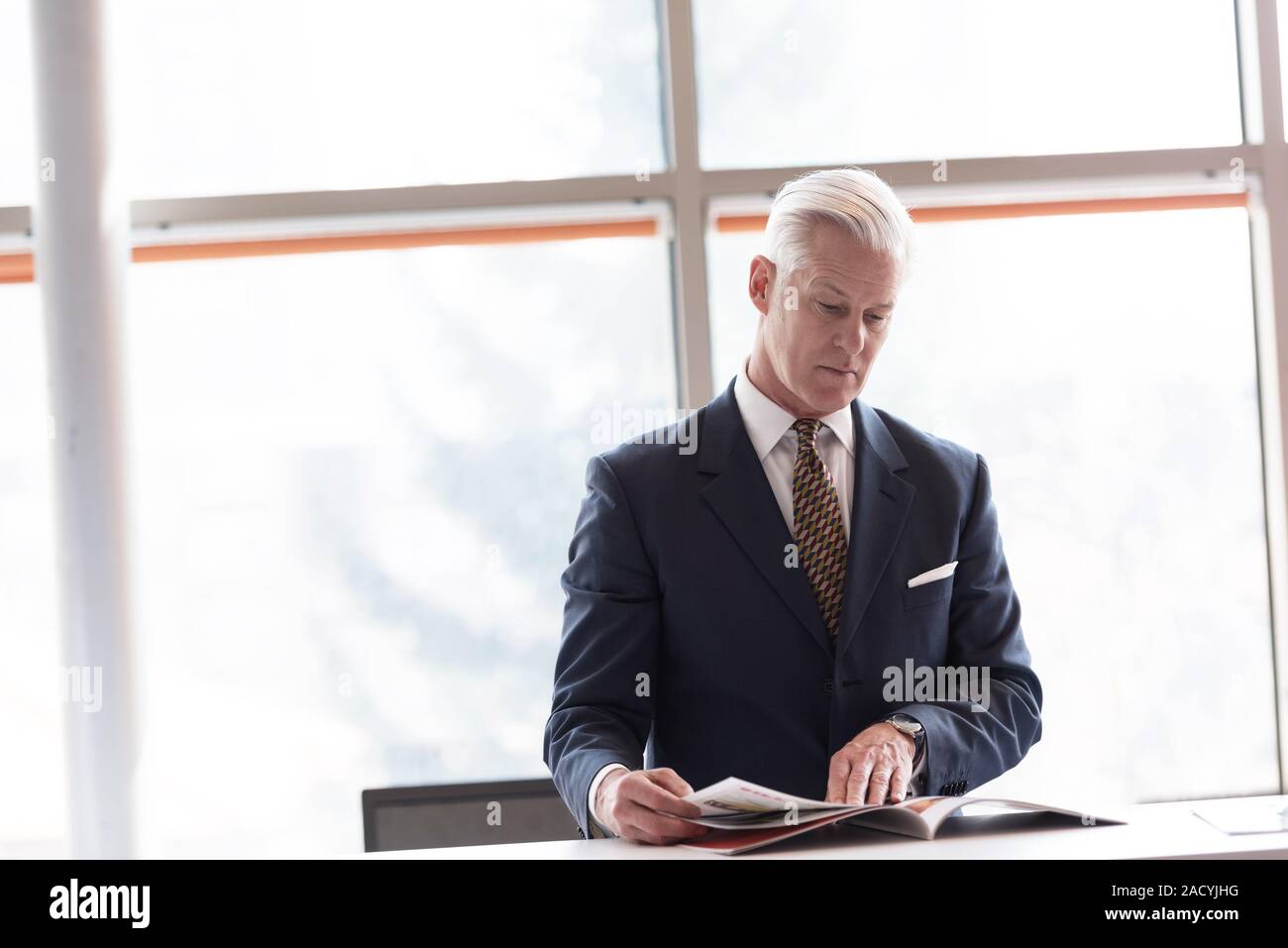 senior Business man reading magazine Stock Photo - Alamy
