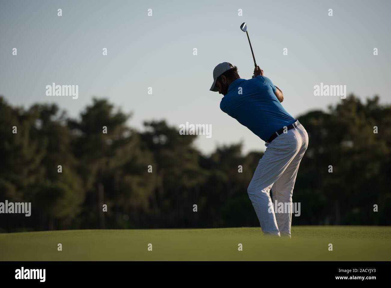 golfer hitting long shot Stock Photo - Alamy