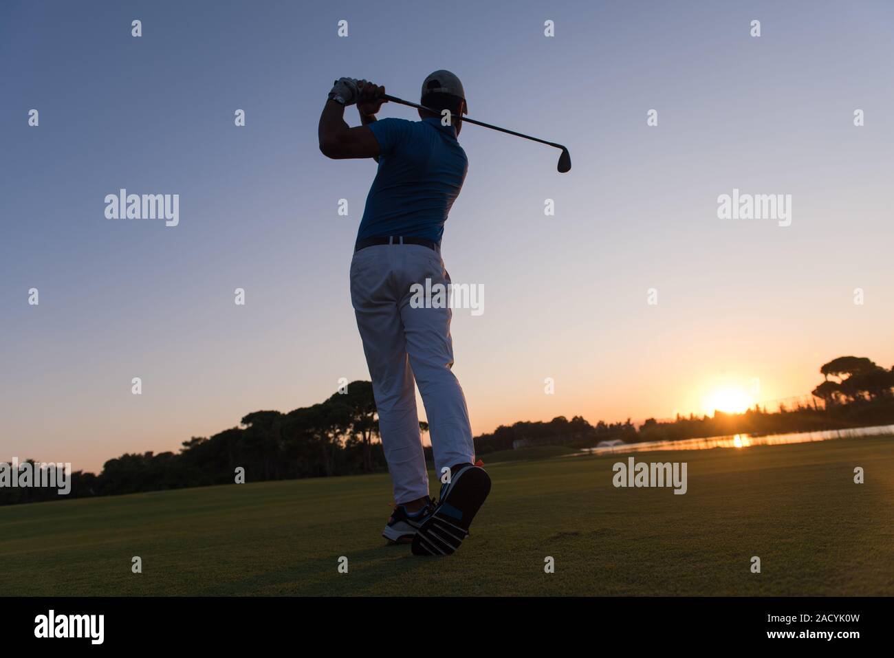 golfer hitting long shot Stock Photo - Alamy