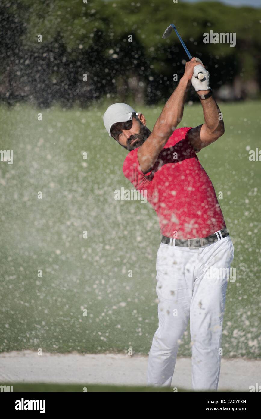 golfer hitting a sand bunker shot Stock Photo - Alamy