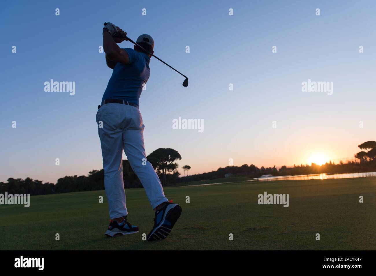 golfer hitting long shot Stock Photo - Alamy