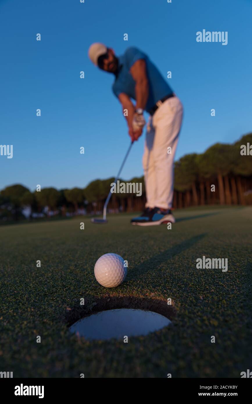 golfer hitting shot at golf course Stock Photo - Alamy