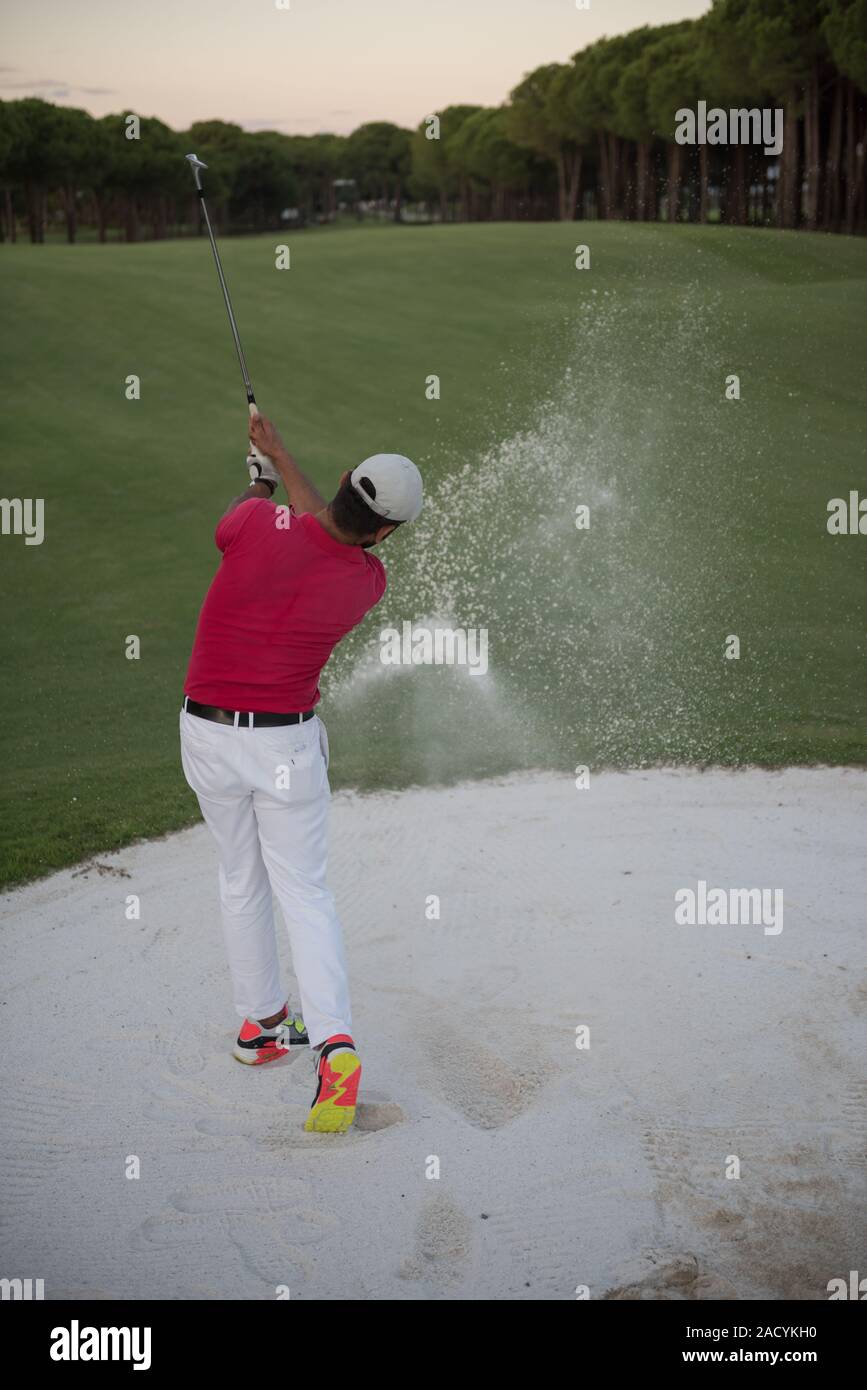 golfer hitting a sand bunker shot on sunset Stock Photo - Alamy