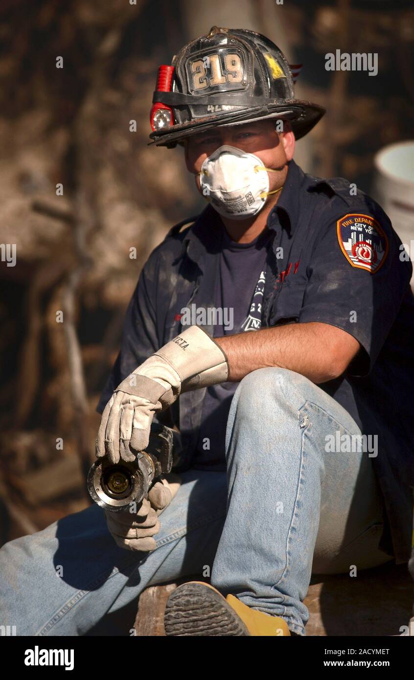 9/11 rescue worker. New York City fireman resting amidst the rubble of ...