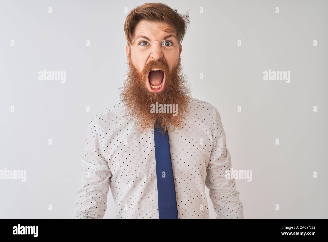 Young redhead irish businessman standing over isolated white background ...