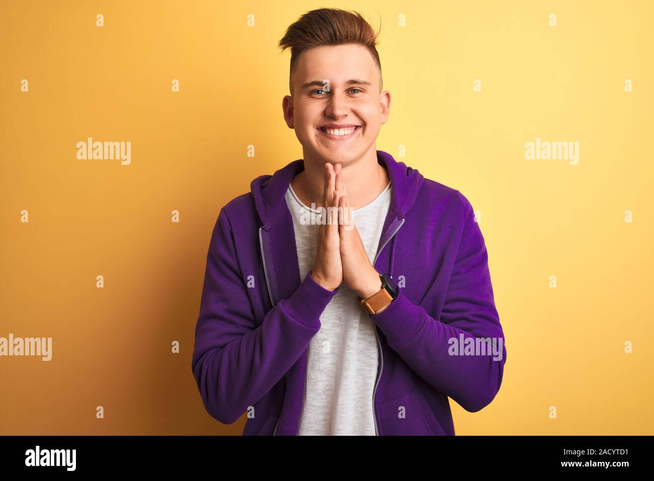 Young handsome man wearing purple sweatshirt standing over isolated ...