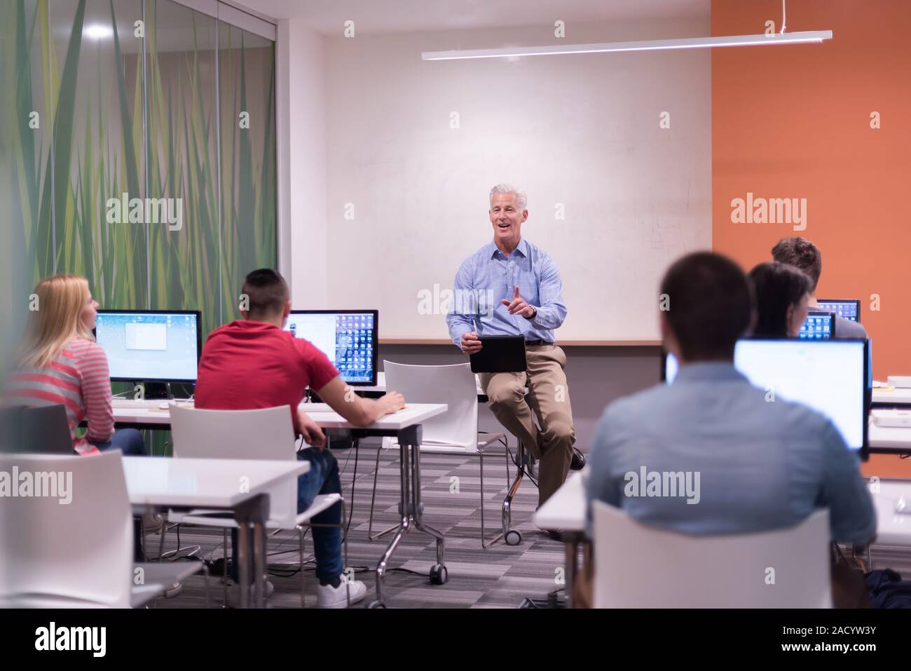 teacher and students in computer lab classroom Stock Photo - Alamy