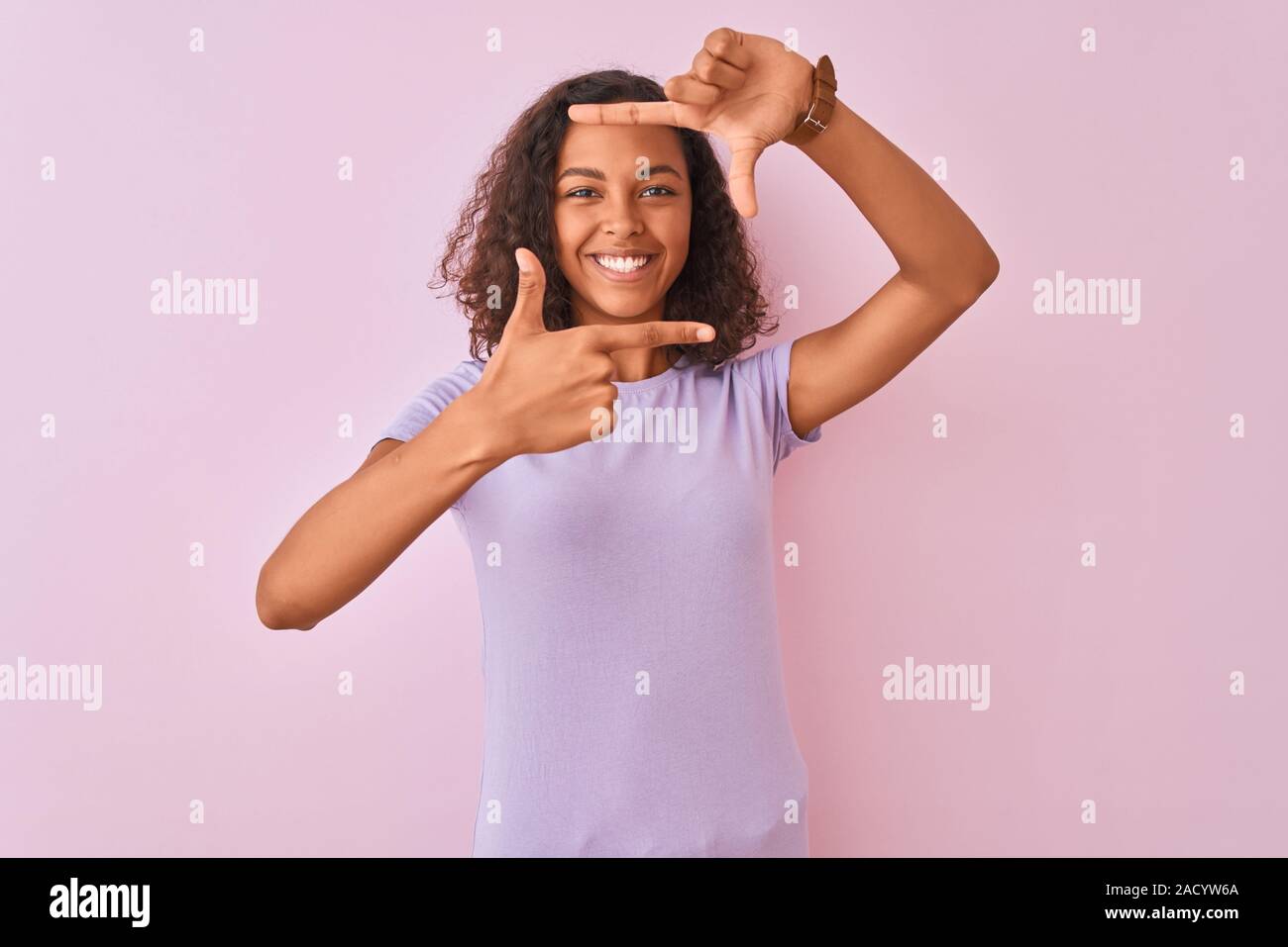 Young Brazilian Woman Wearing T Shirt Standing Over Isolated Pink