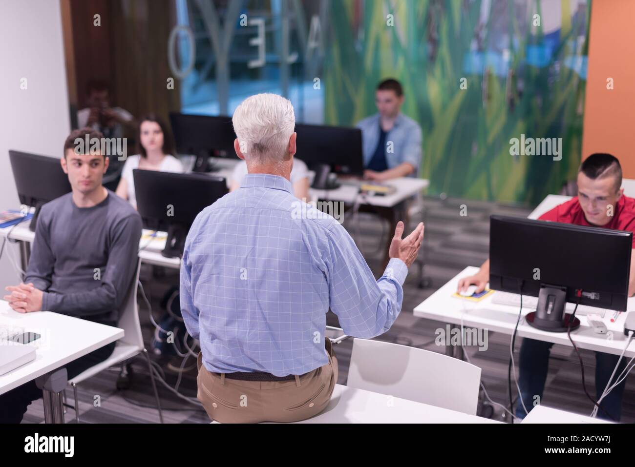 teacher and students in computer lab classroom Stock Photo - Alamy