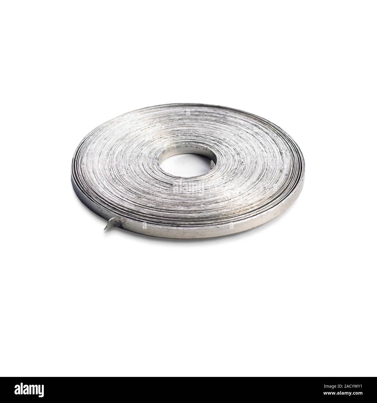 A coil of magnesium ribbon. Magnesium is an alkaline earth metal, with ...