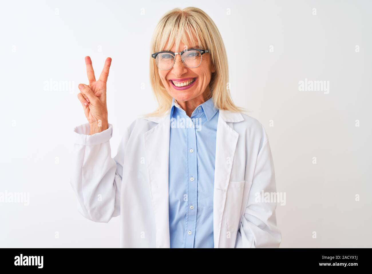 Middle age scientist woman wearing glasses standing over isolated white ...