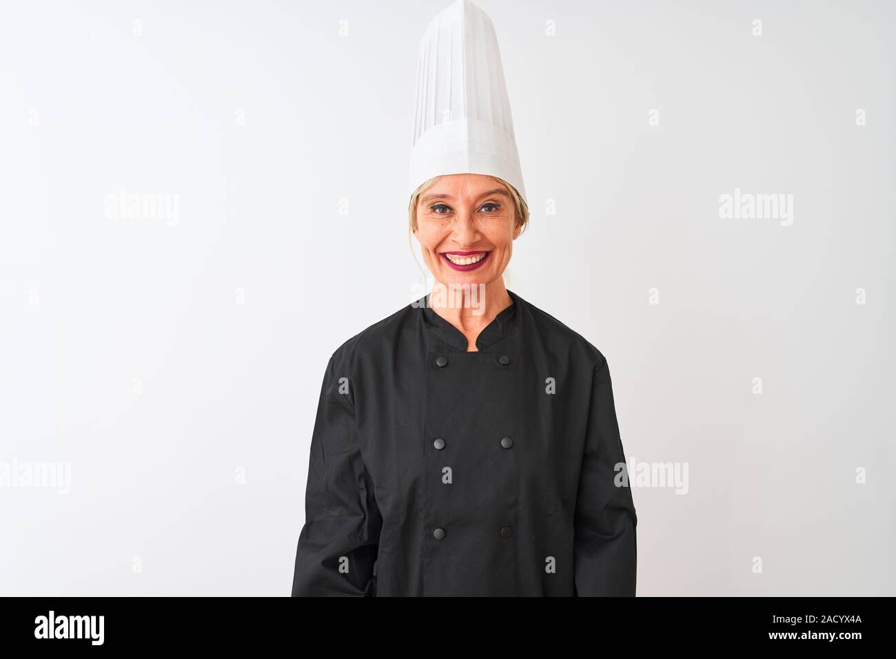 Middle age chef woman wearing uniform and hat standing over isolated ...