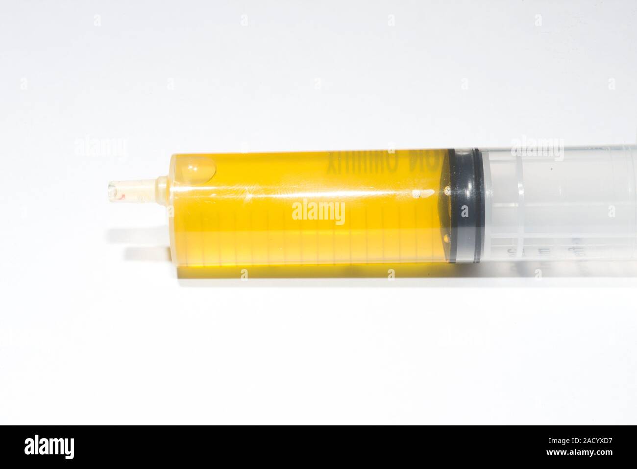 Fluid removed from knee. Syringe containing synovial fluid removed ...