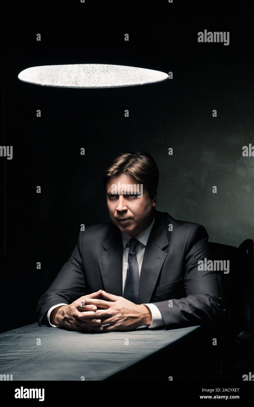 Side view of man in dark room illuminated by lamp Stock Photo - Alamy