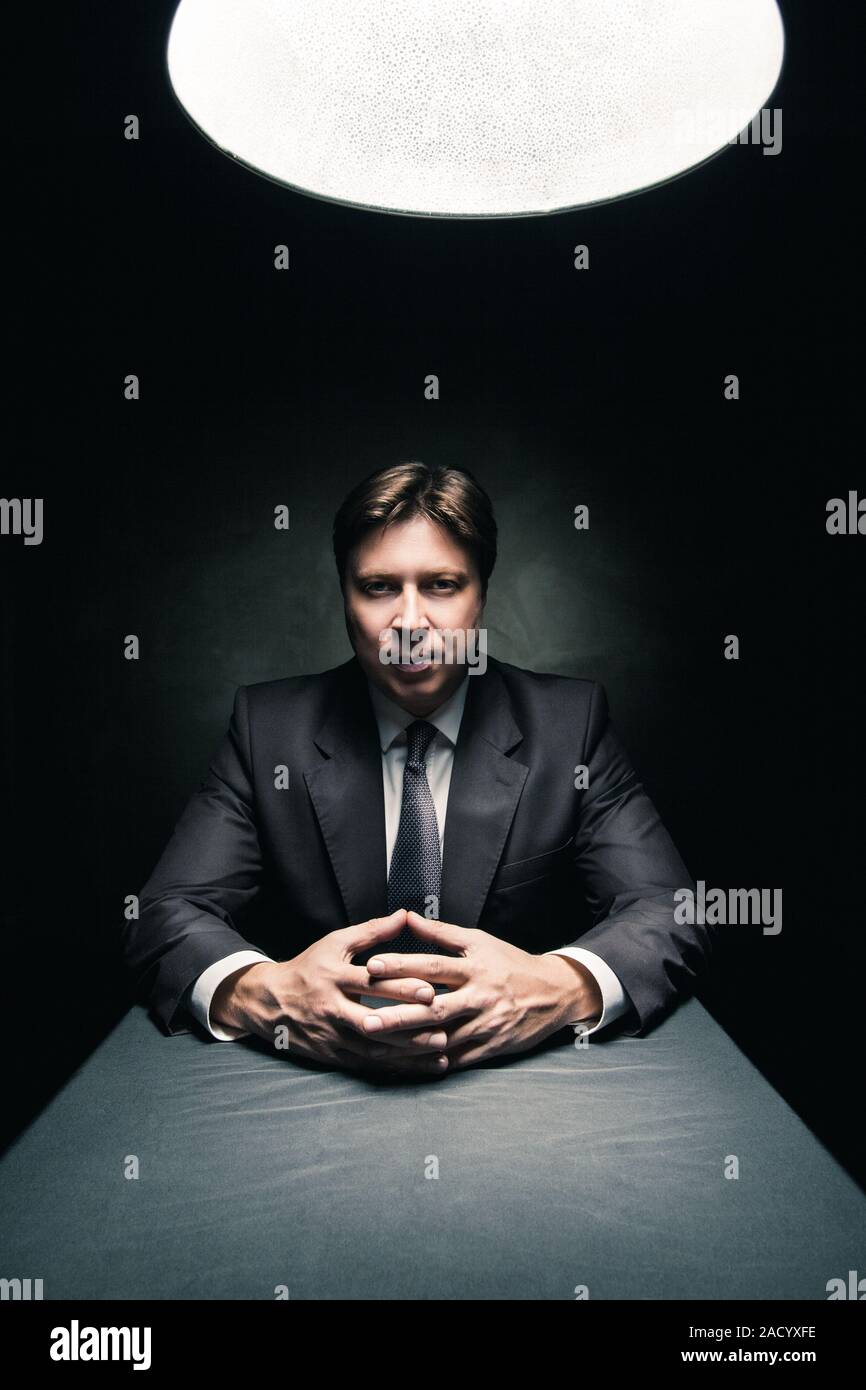 Man wearing suit in dark room illuminated by lamp Stock Photo - Alamy