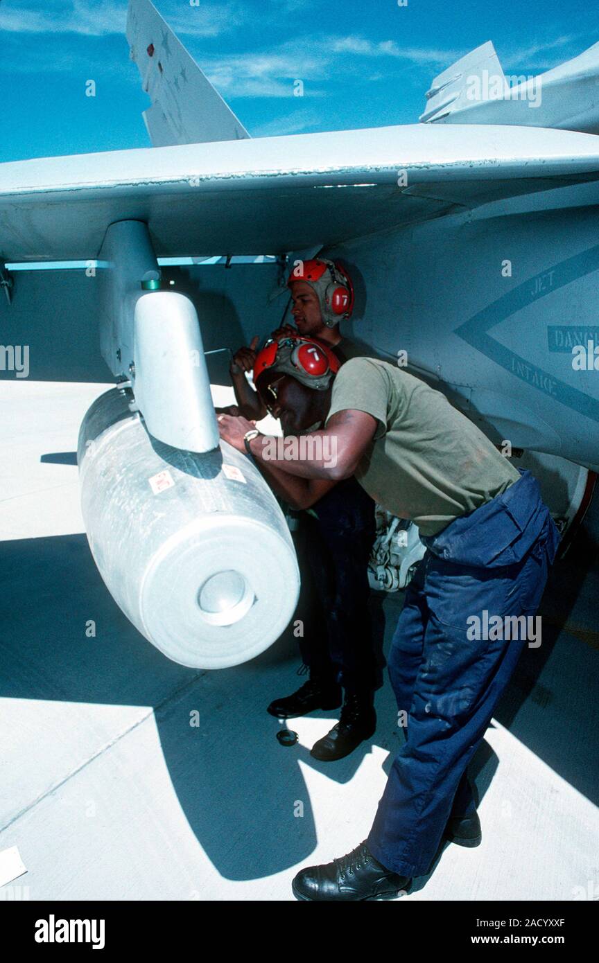Napalm bomber. Ground crewmen securing a Mark 77 napalm bomb to the ...
