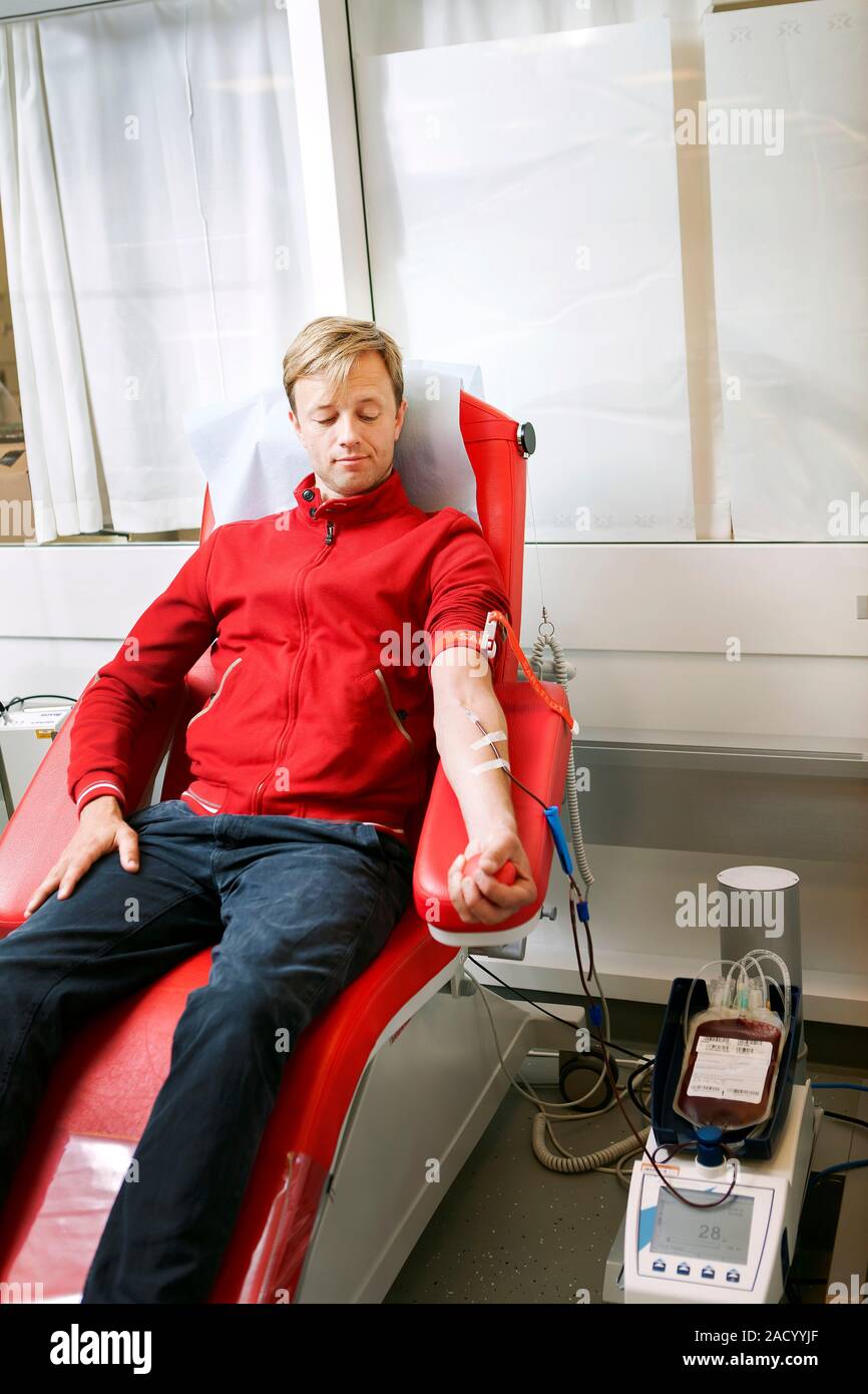 Blood donation clinic. Man giving blood in a blood donation centre ...