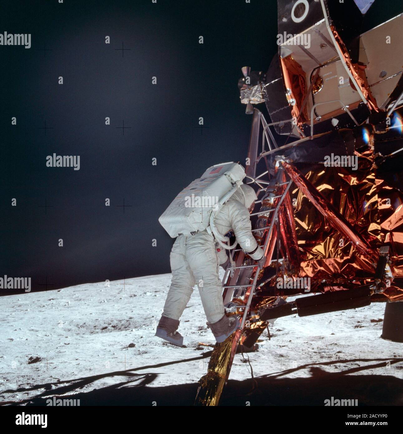 Apollo 11 Moon landing. Buzz Aldrin stepping down the ladder of the Eagle landing module and ...