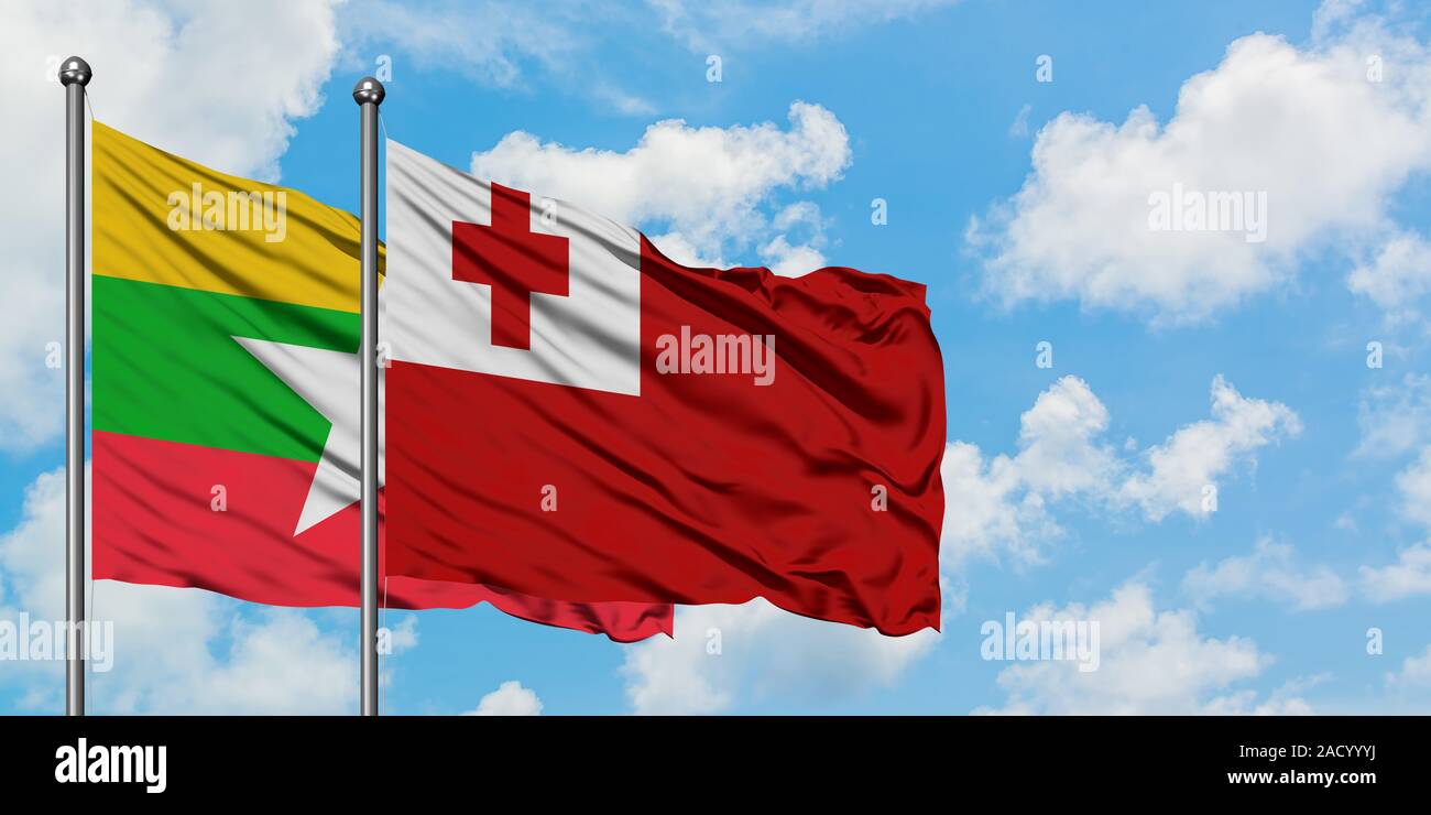 Myanmar and Tonga flag waving in the wind against white cloudy blue sky ...