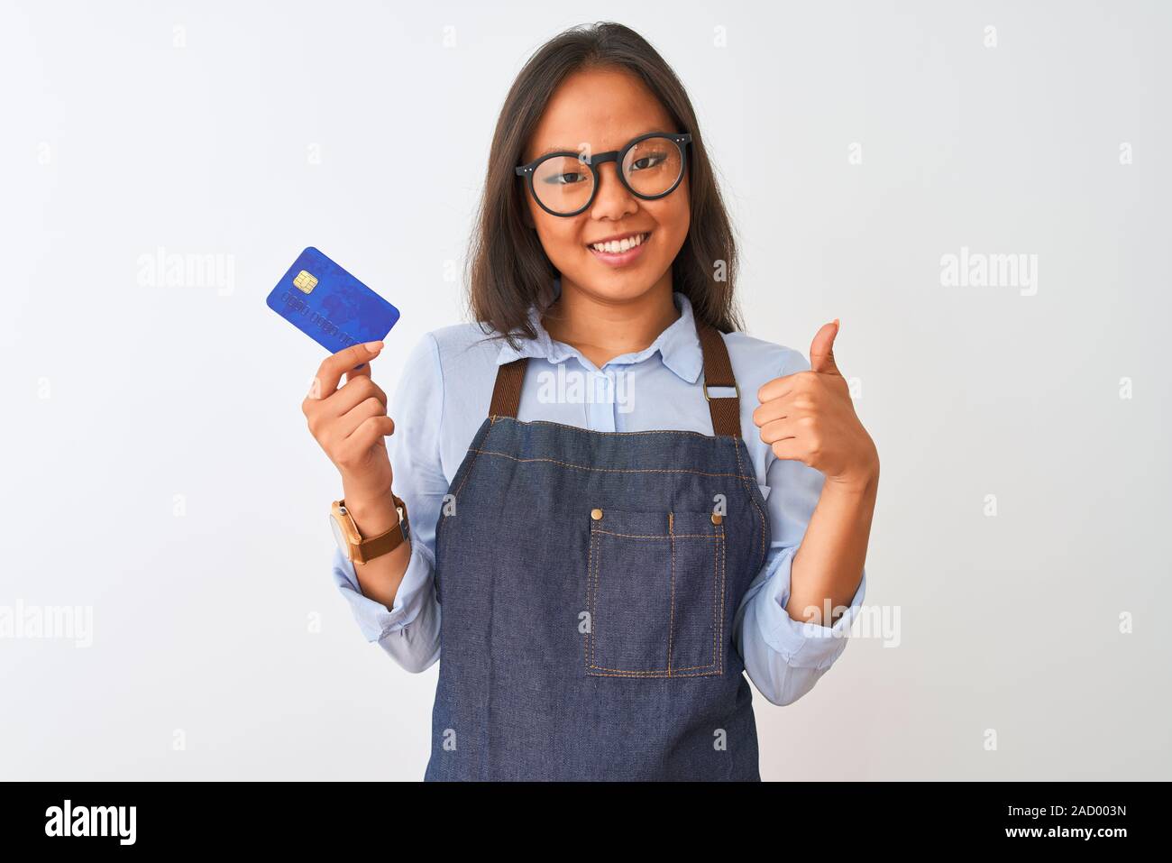 Chinese shopkeeper woman wearing glasses holding credit card over ...