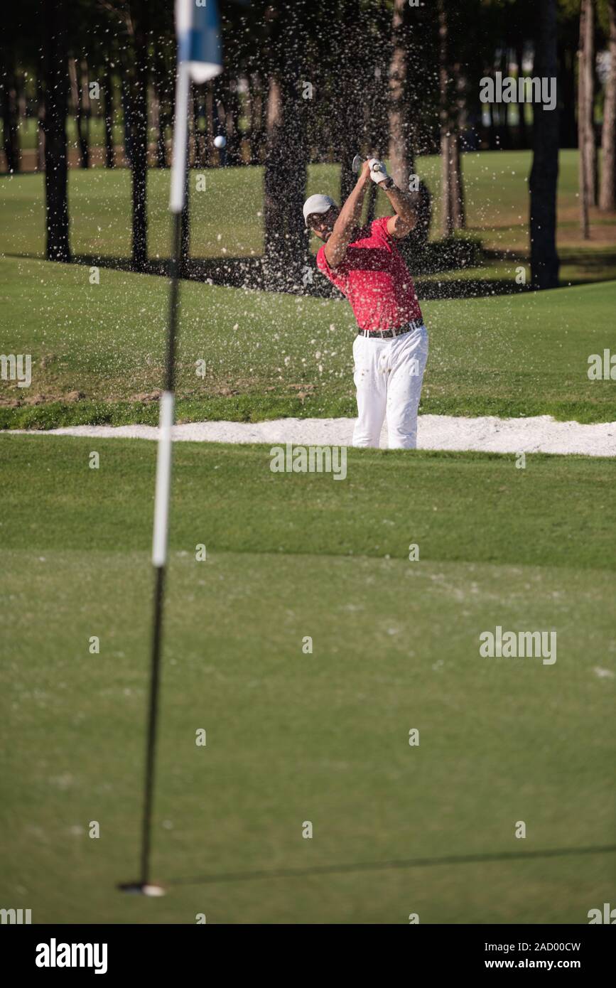 golfer hitting a sand bunker shot Stock Photo - Alamy