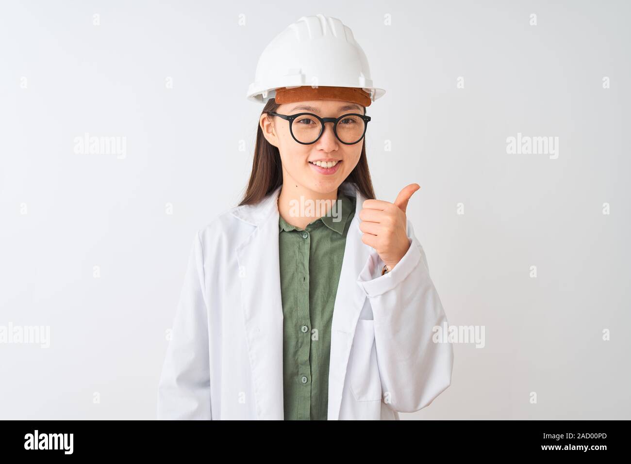 Young chinese engineer woman wearing coat helmet glasses over isolated ...