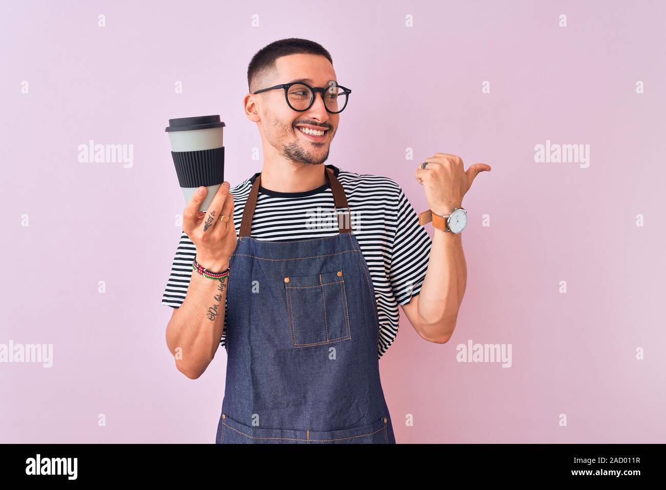 Young handsome barista man wearing uniform over isolated background ...