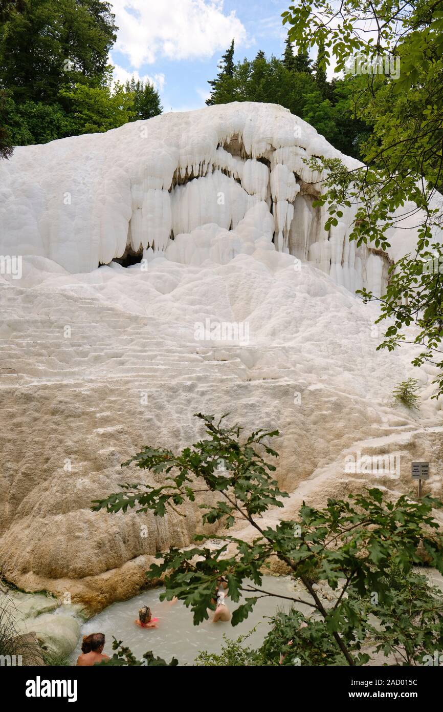 The natural hot springs, bathers and the white calcium concretion ...