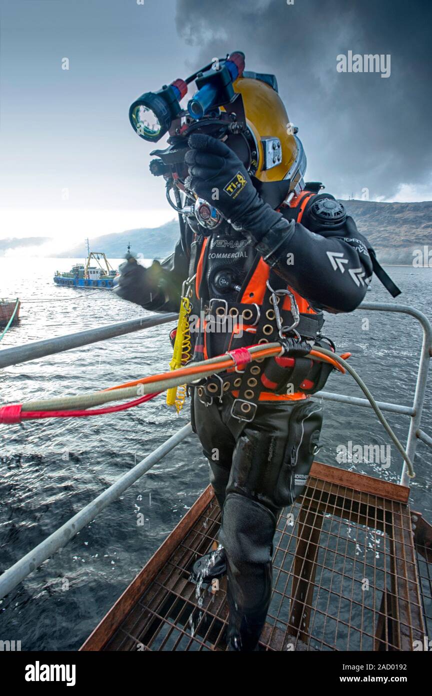 Commercial diver in diving suit. Commercial diver wearing his diving ...
