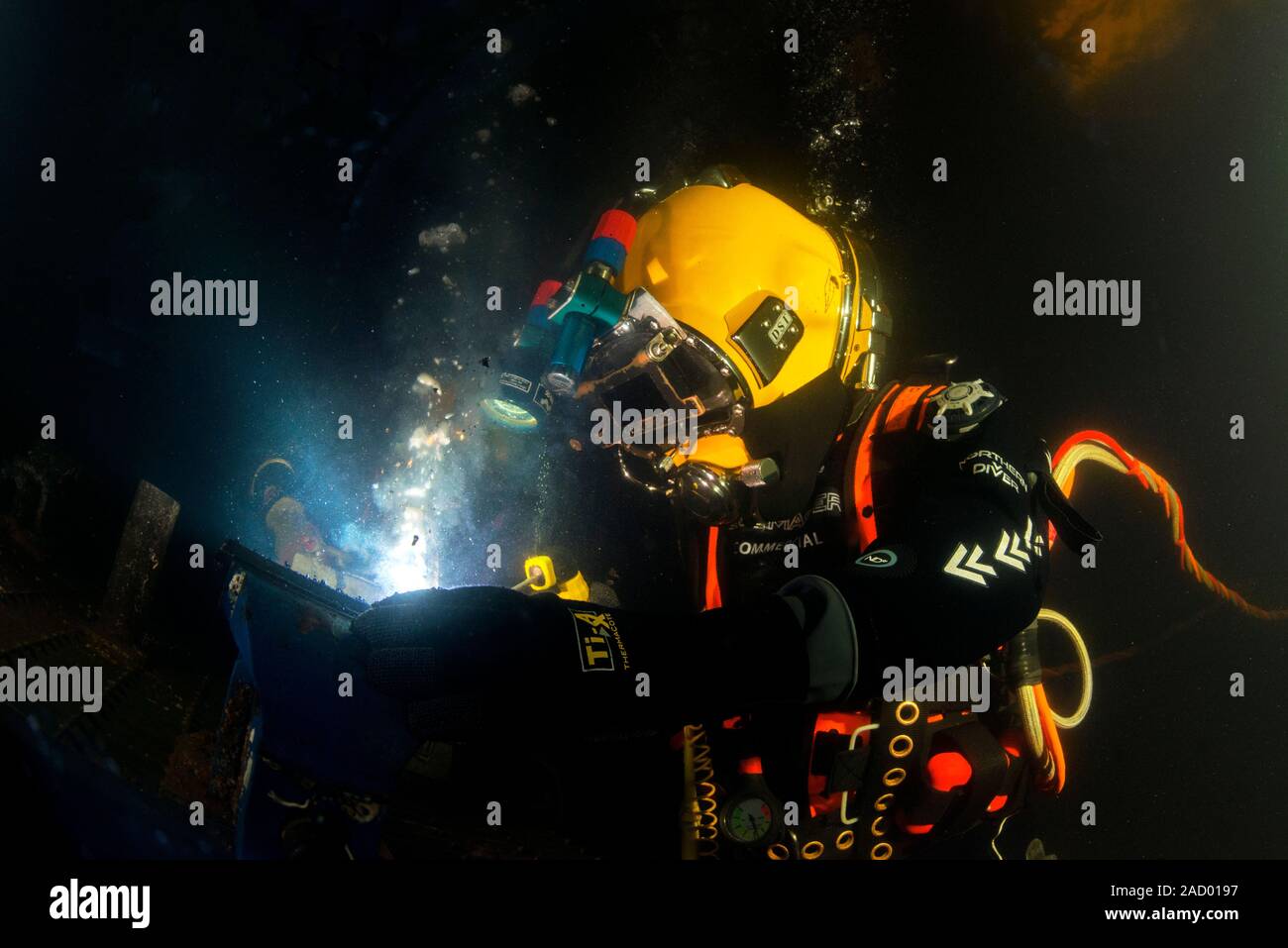 Commercial diver welding. Commercial diver using an electric arc welder ...