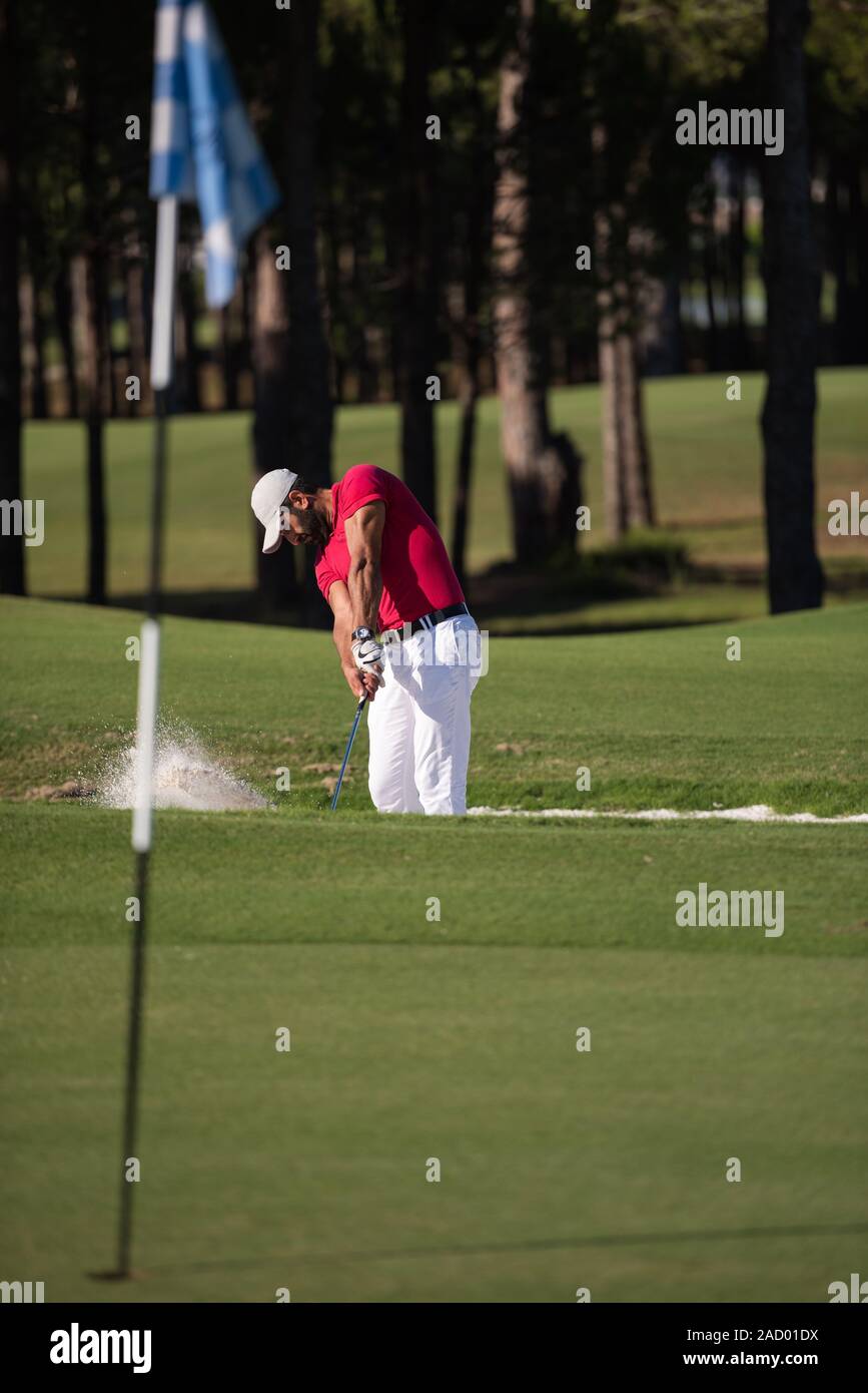 golfer hitting a sand bunker shot Stock Photo - Alamy