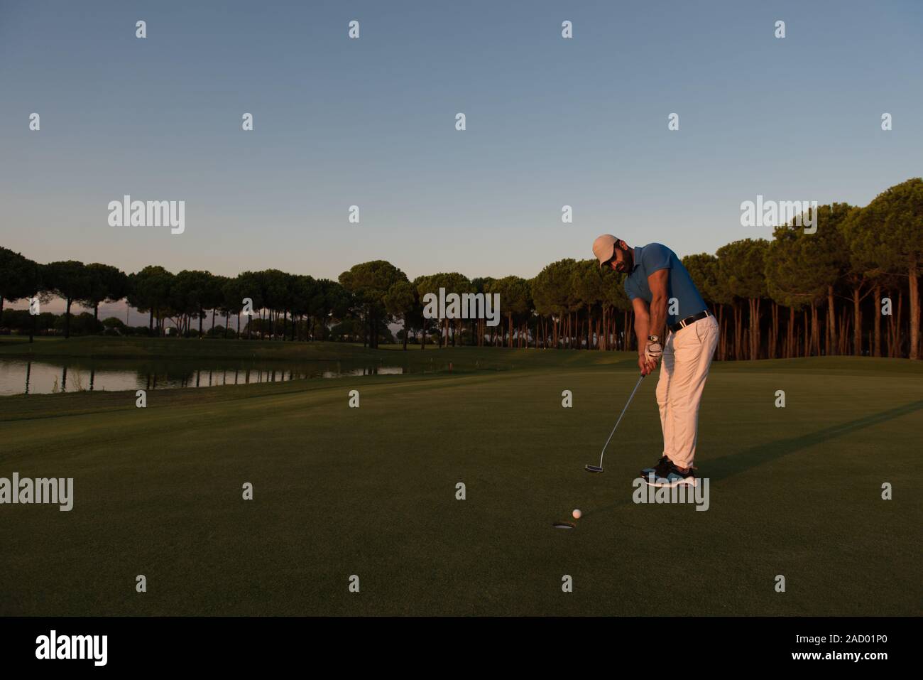 golfer hitting shot at golf course Stock Photo - Alamy