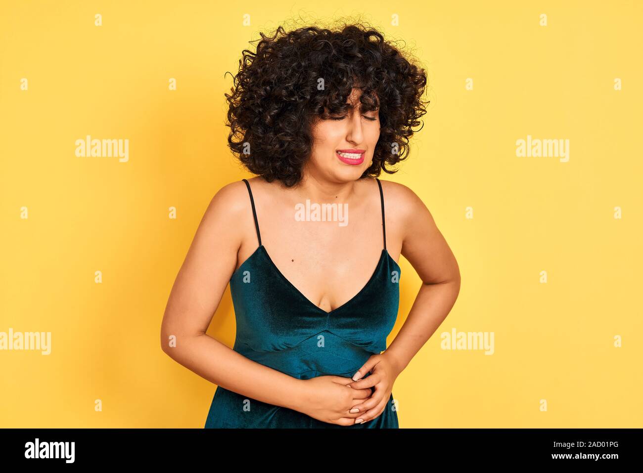 Young arab woman with curly hair wearing elegant dress over isolated ...