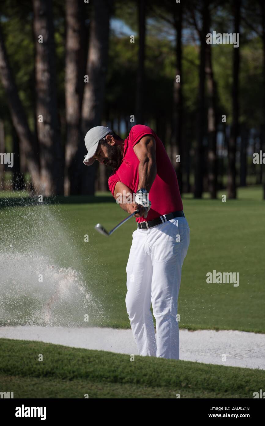 golfer hitting a sand bunker shot Stock Photo - Alamy