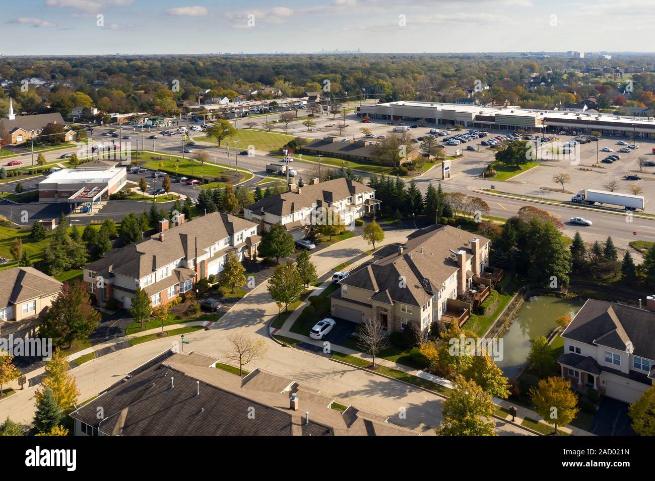 Aerial view of a townhouse community near a bank and shopping center ...
