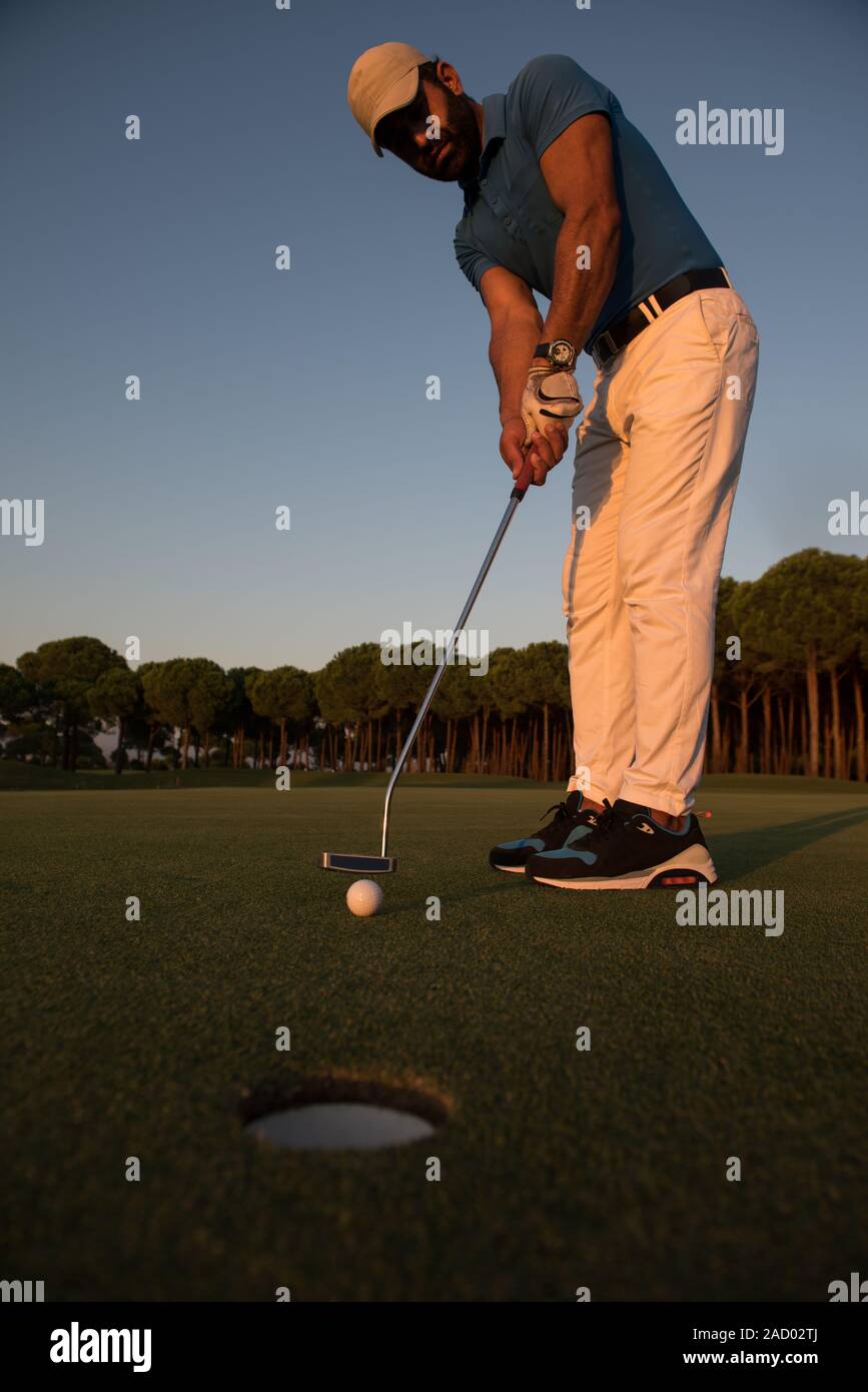 golfer hitting shot at golf course Stock Photo - Alamy
