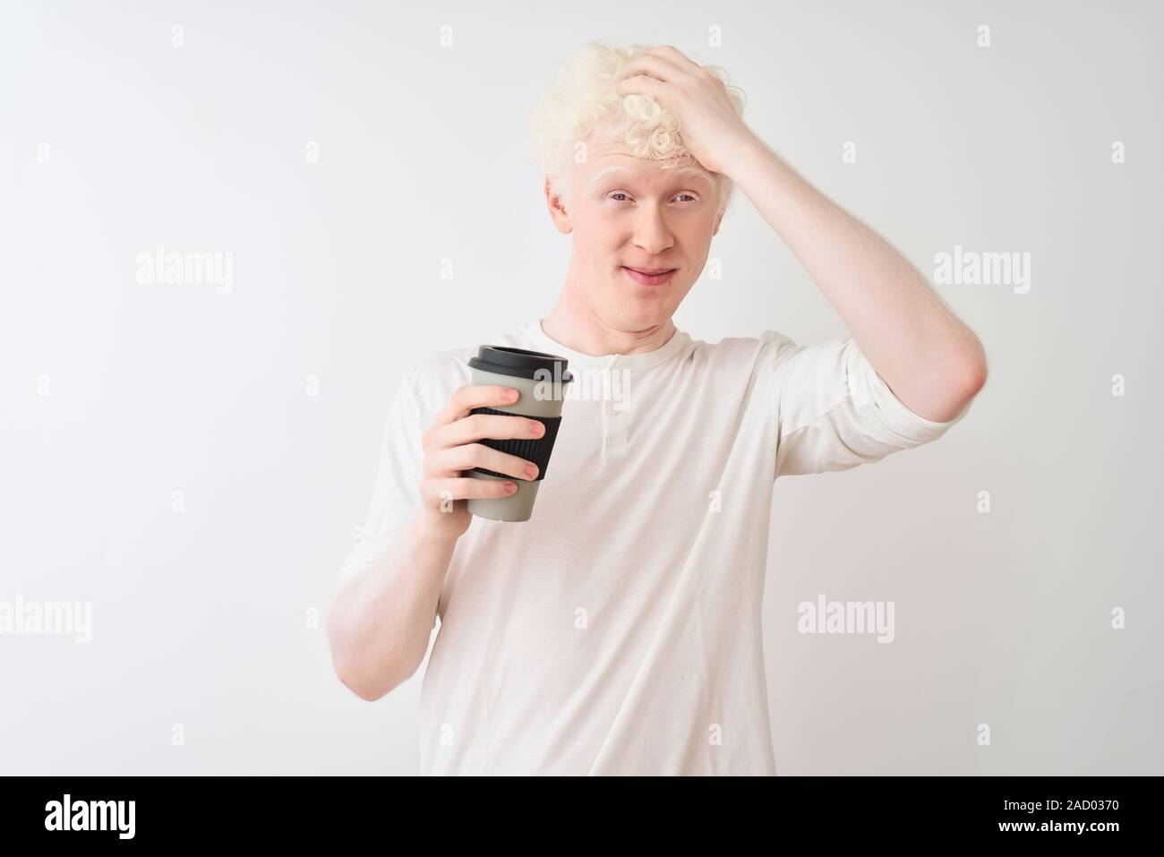 Young albino blond man drinking coffee standing over isolated white ...