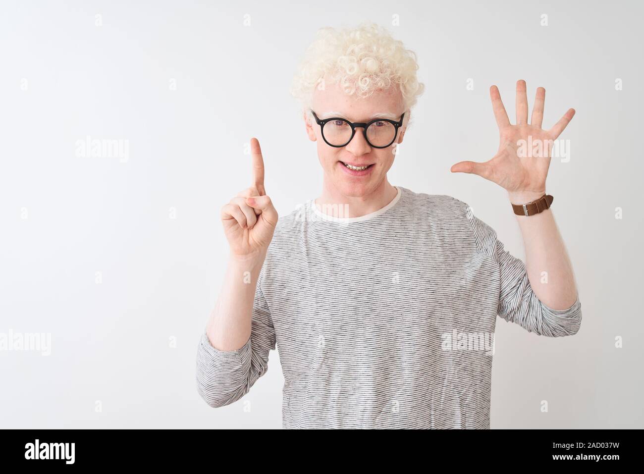 Young albino blond man wearing striped t-shirt and glasses over ...