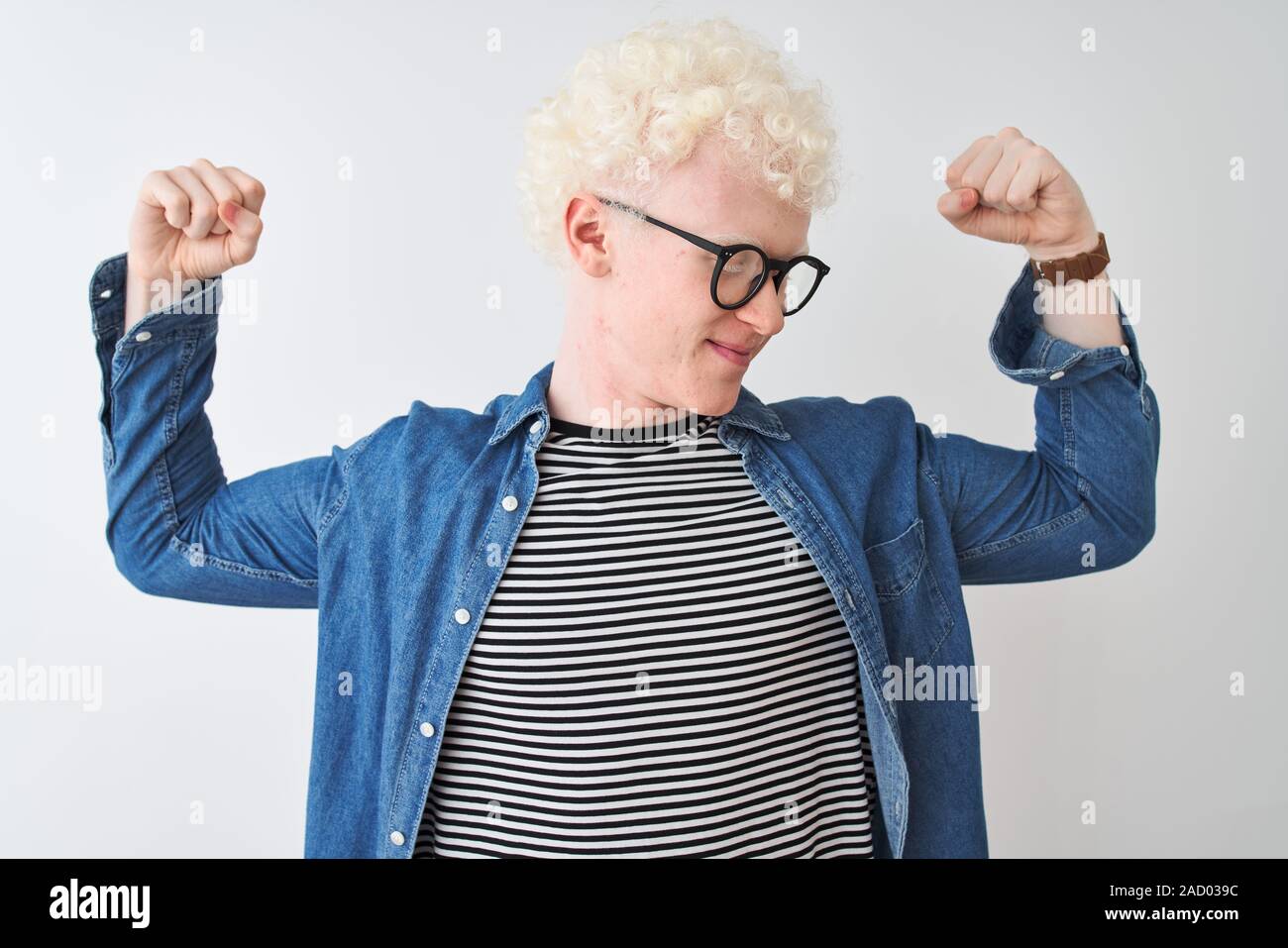 Young albino blond man wearing denim shirt and glasses over isolated ...