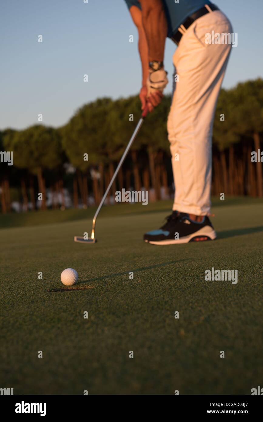 golfer hitting shot at golf course Stock Photo - Alamy