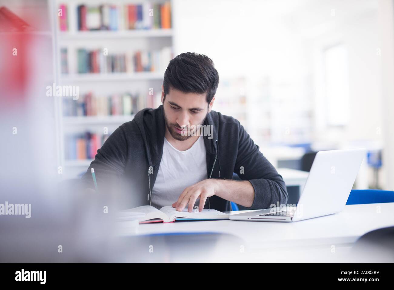 student in school library using laptop for research Stock Photo - Alamy