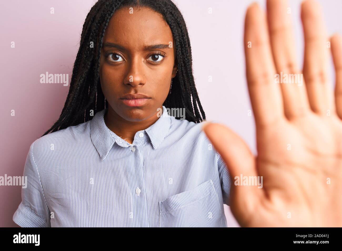 Young African American Woman Wearing Striped Shirt Standing Over
