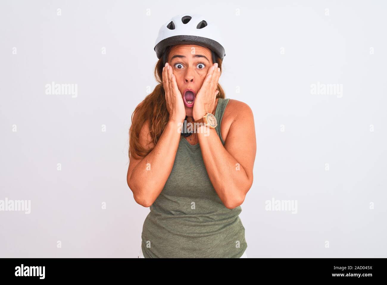 Middle age mature cyclist woman wearing safety helmet over isolated ...