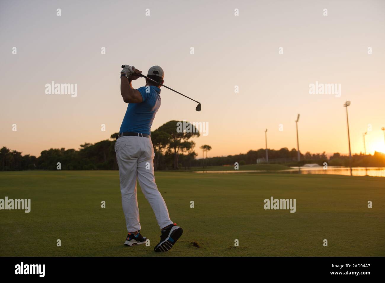 golfer hitting long shot Stock Photo - Alamy