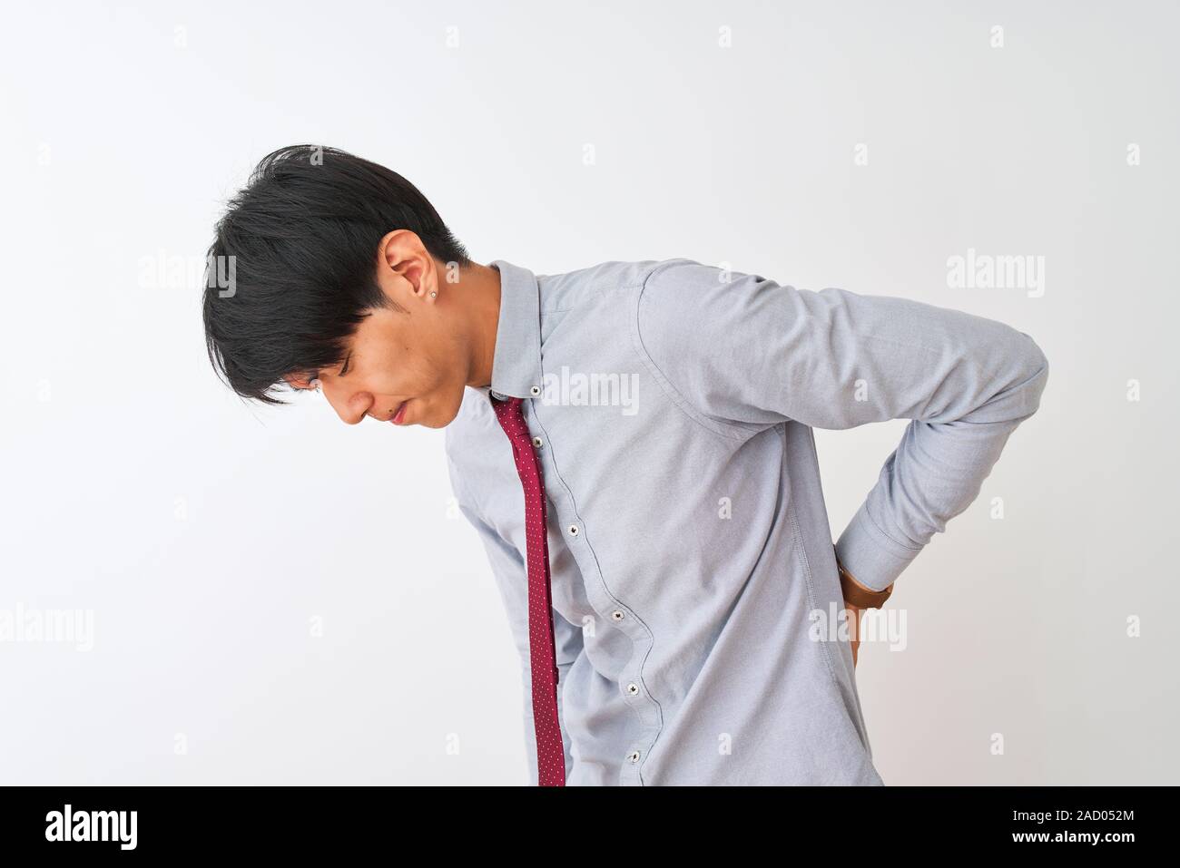 Chinese businessman wearing elegant tie standing over isolated white ...