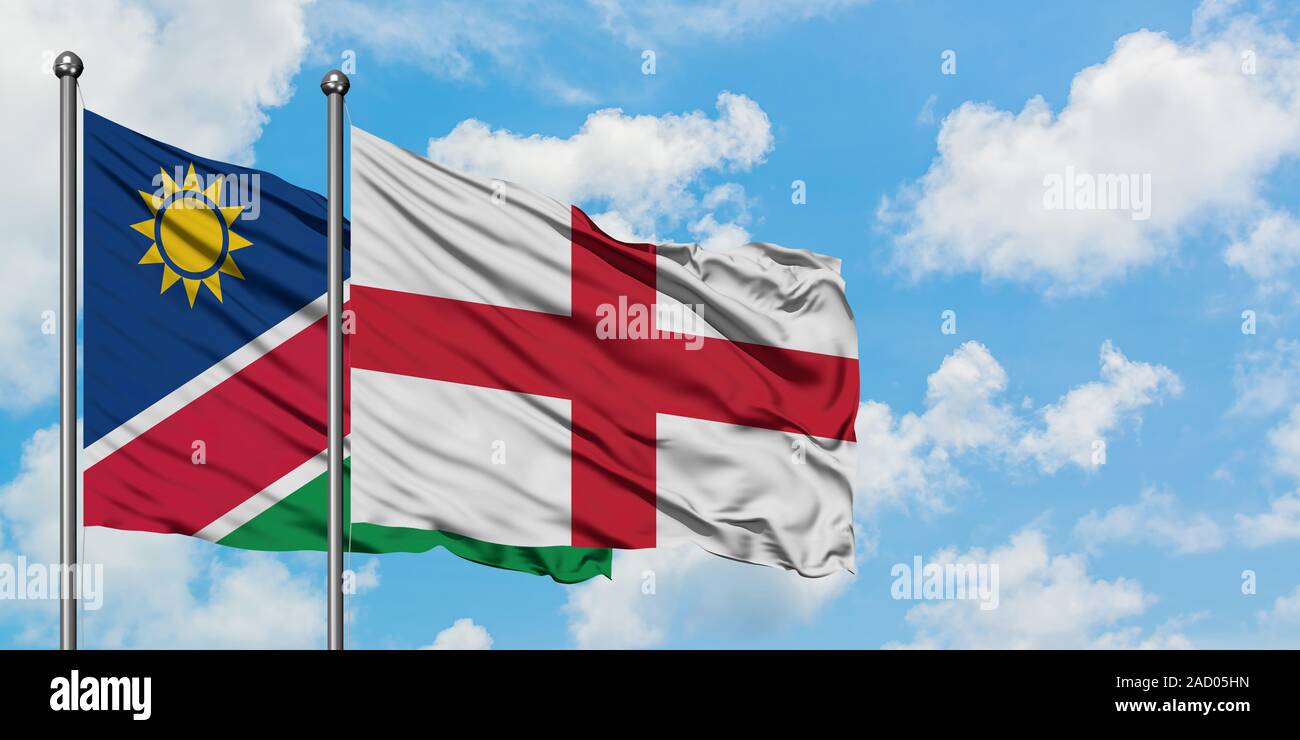 Namibia and England flag waving in the wind against white cloudy blue ...