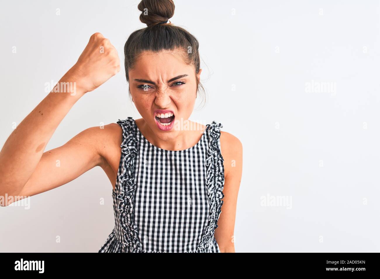Beautiful woman with bun wearing casual dresss standing over isolated ...