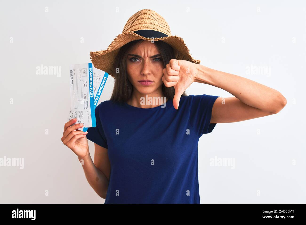 Young beautiful tourist woman holding boarding pass ticket over ...
