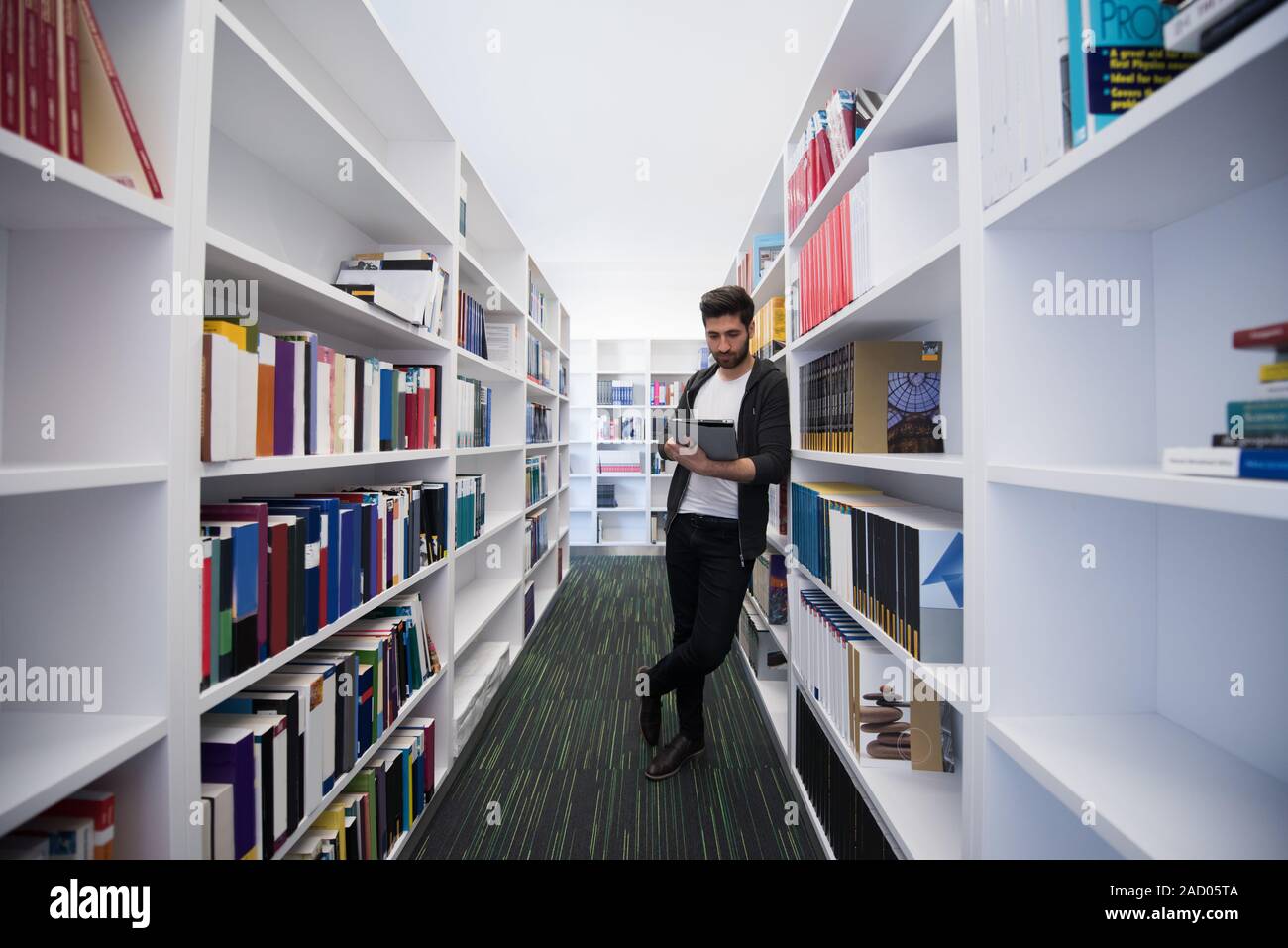 student with tablet in library Stock Photo - Alamy